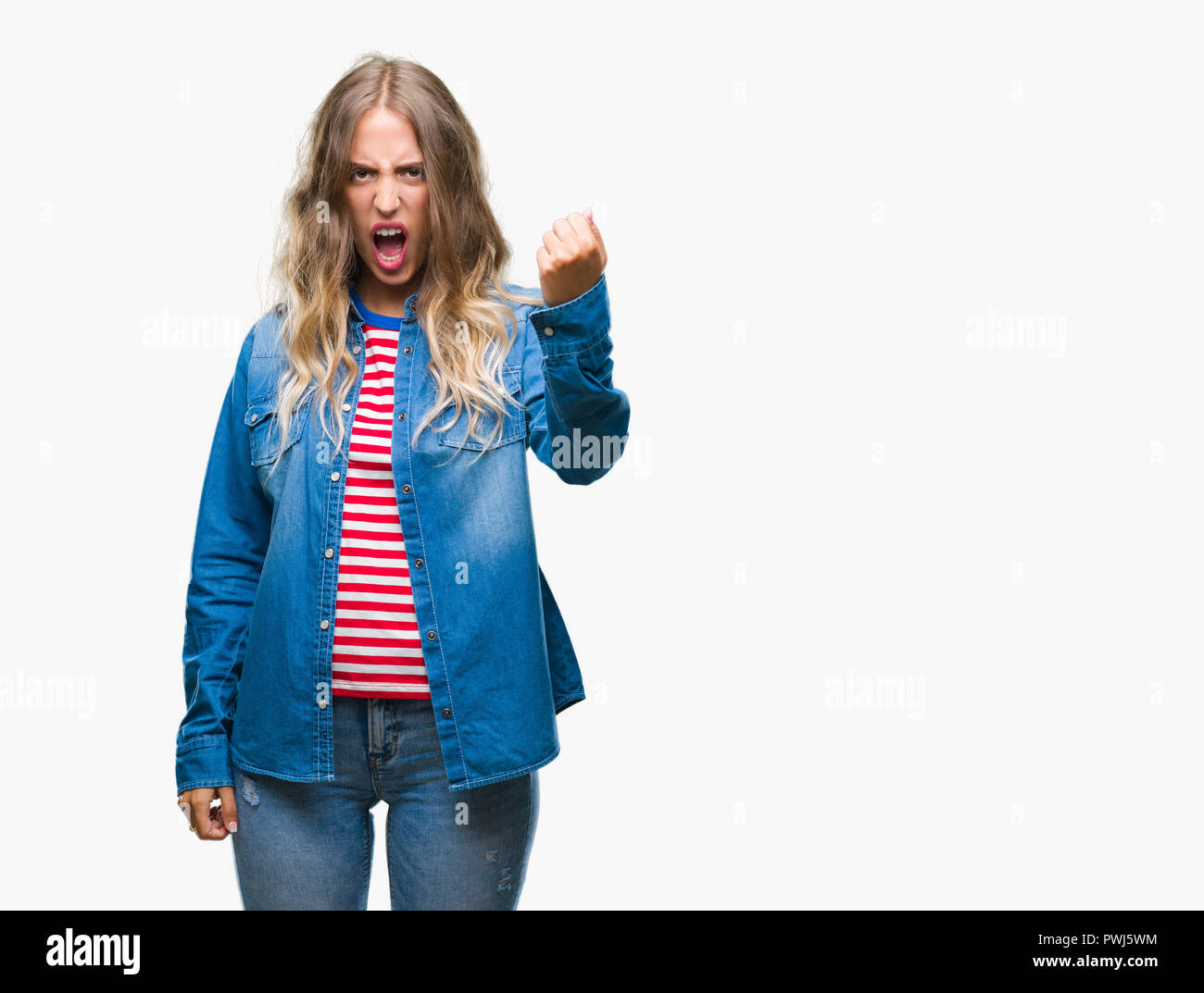Beautiful young blonde woman over isolated background angry and mad ...