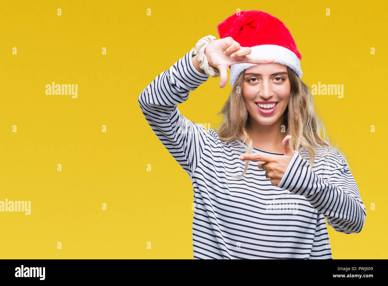 Beautiful Young Blonde Woman Wearing Christmas Hat Over Isolated