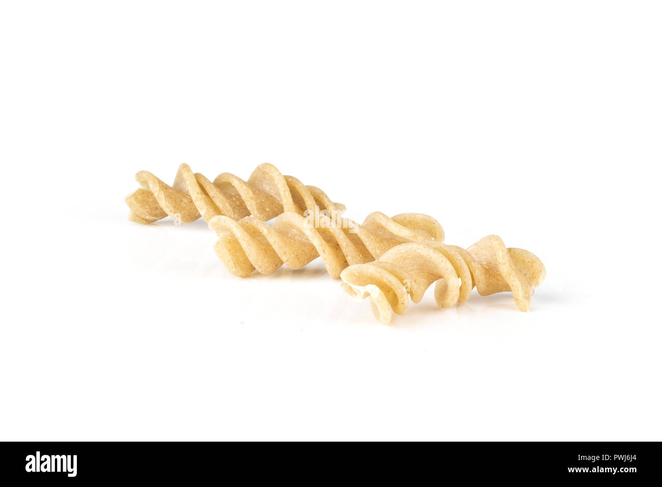Set of three whole raw pasta fusilli variety isolated on white ...