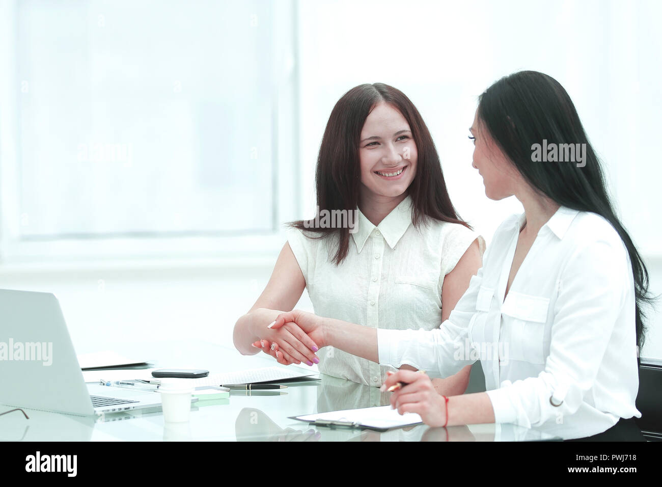 two business women shaking hands with each other.photo with copy space ...