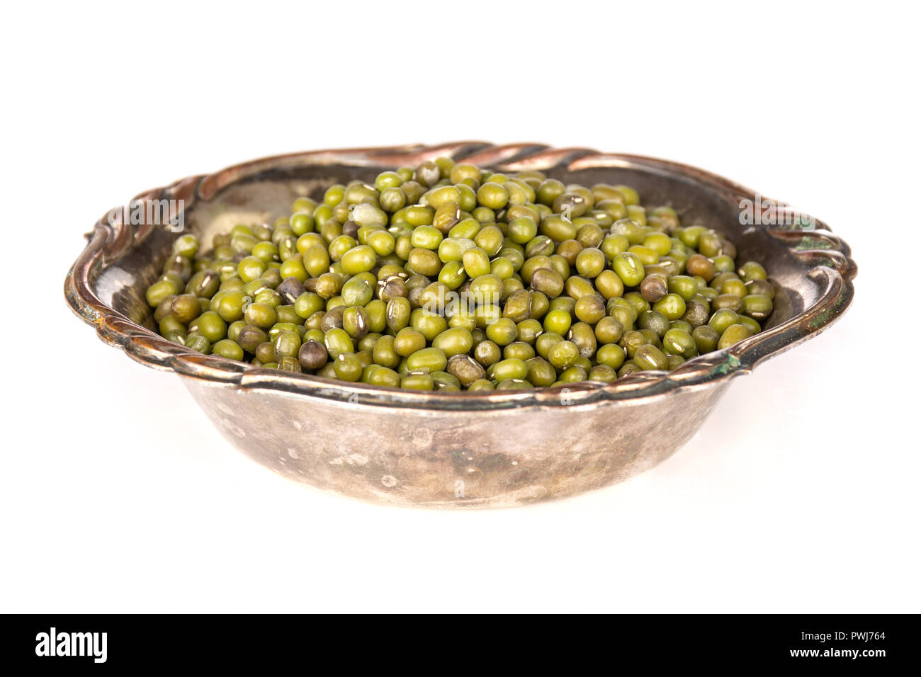 Lot of whole dry green mung beans in old iron bowl isolated on white ...
