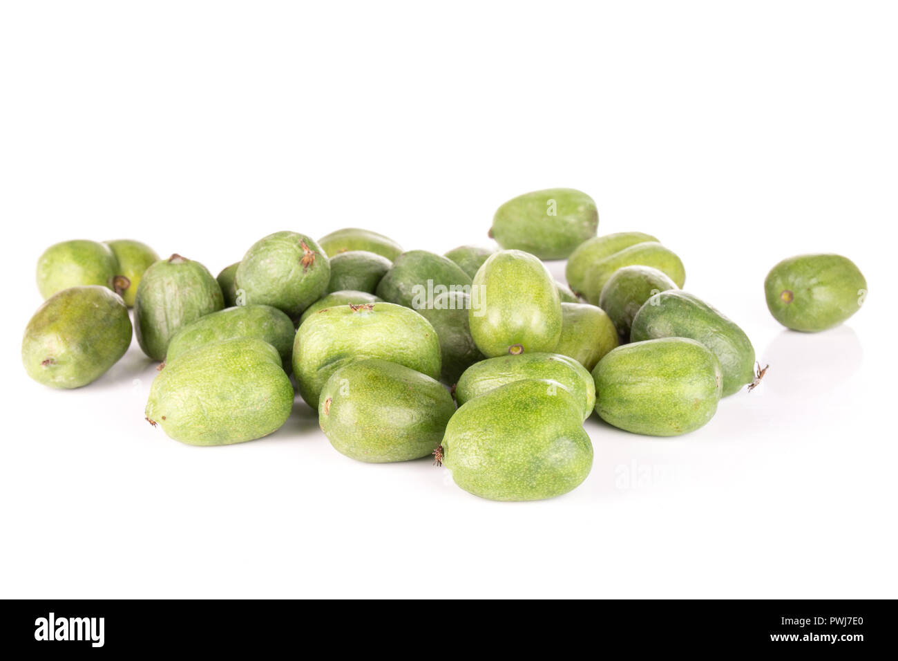 Lot of whole fuzzless fresh green mini baby kiwi fruit isolated on ...