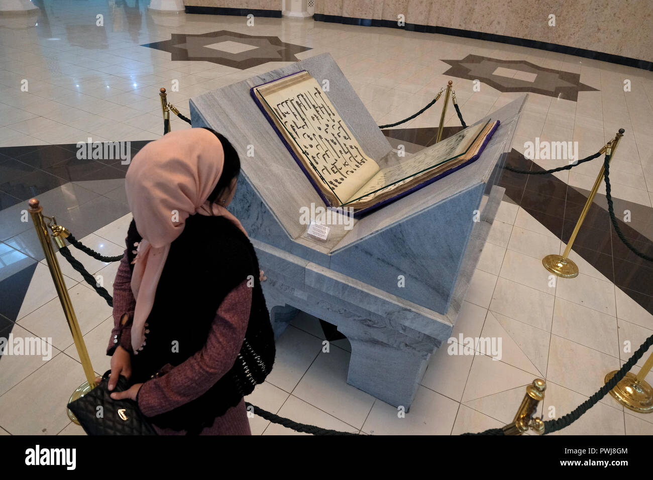 An Uzbek visitor looks at a 1905 facsimile copy of Othman Koran written ...