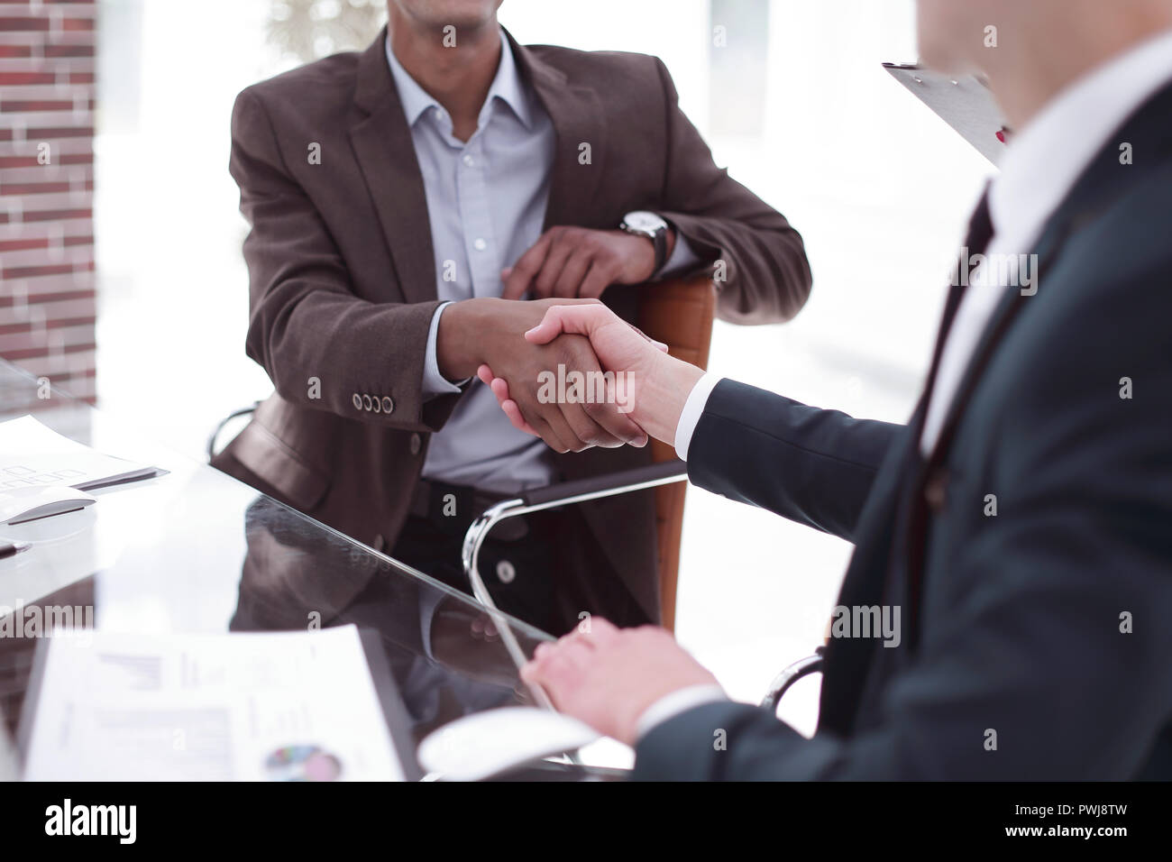 closeup handshake international partners on a Desk Stock Photo - Alamy