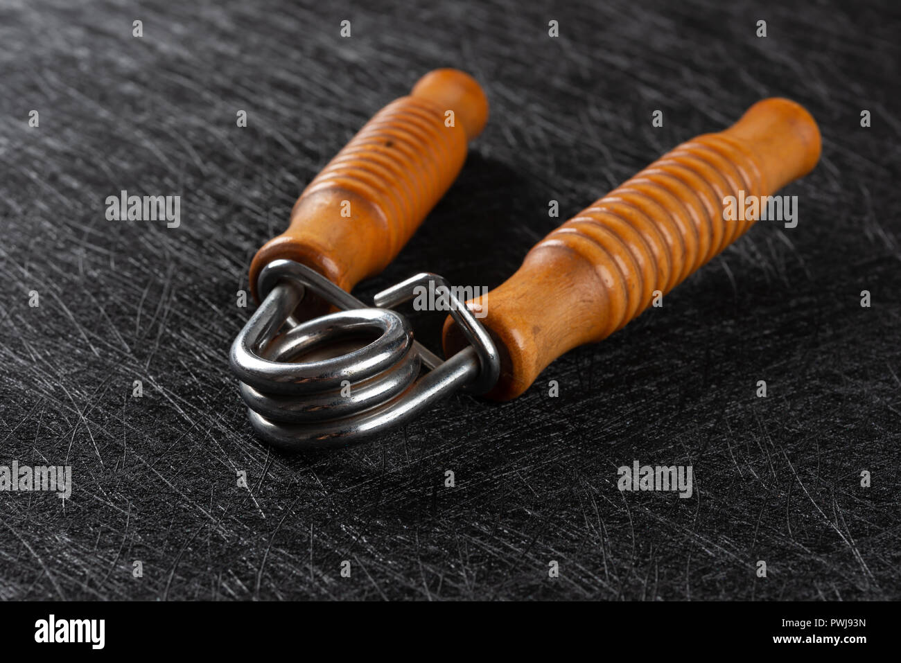 wooden handles hand trainer on dark background Stock Photo - Alamy