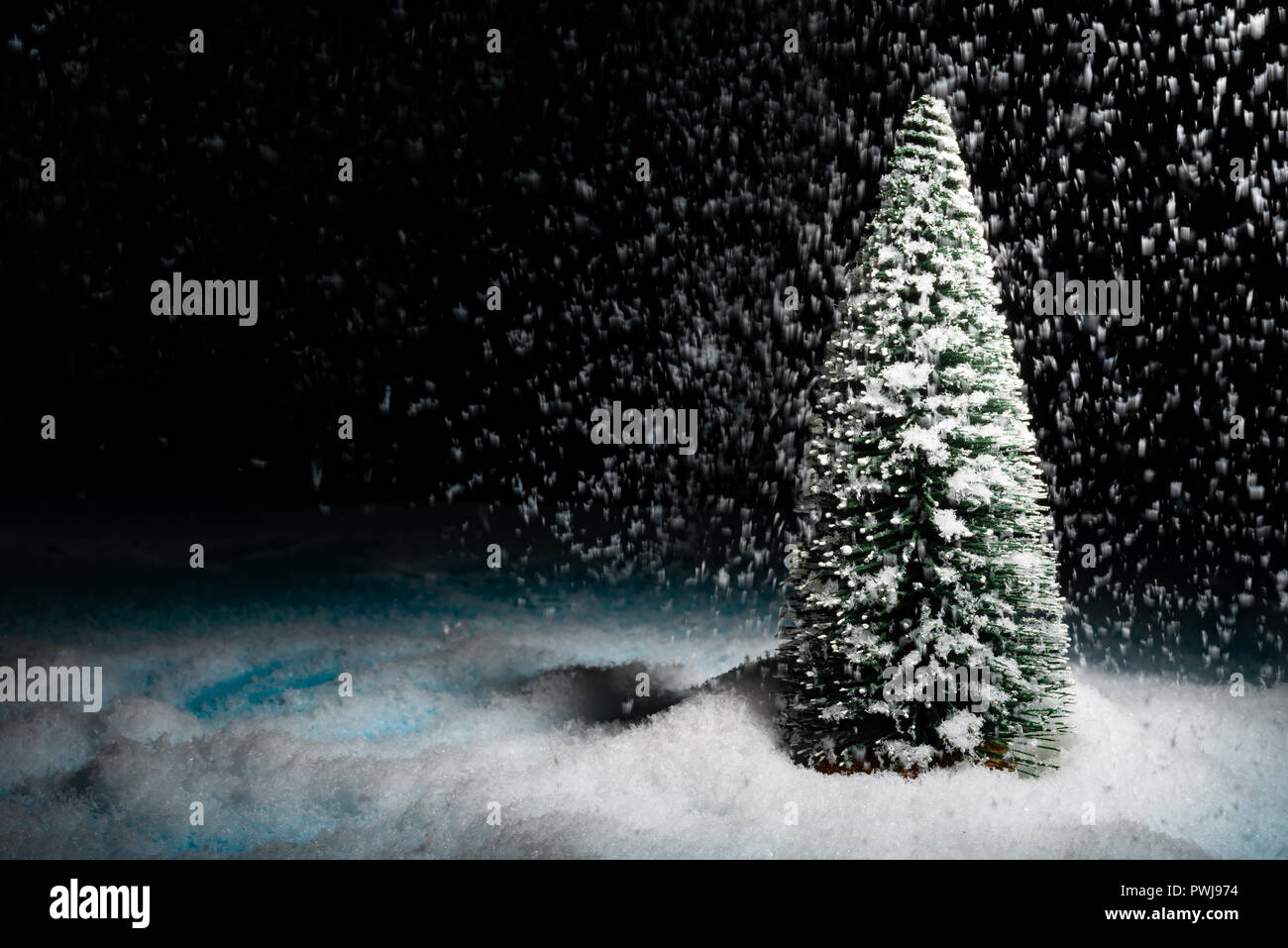 highlighted scene of christmas tree with snow Stock Photo - Alamy
