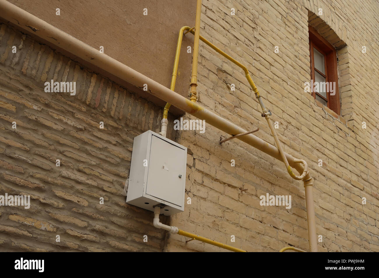 Residential gas pipes running along outer wall of a house in the old ...