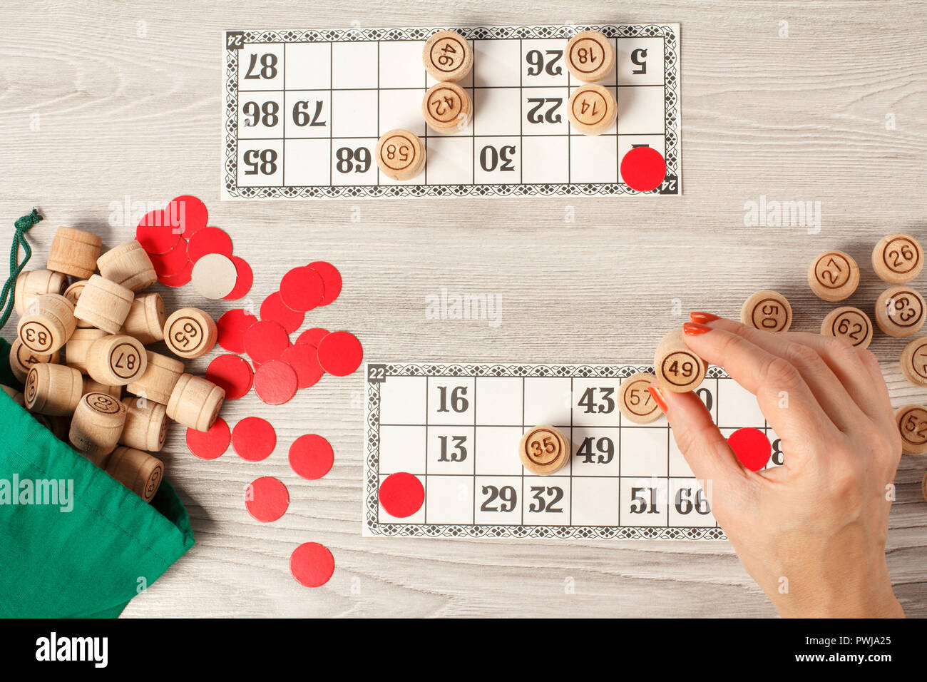 Female hand holding a barrel for a game in lotto. Wooden lotto barrels ...