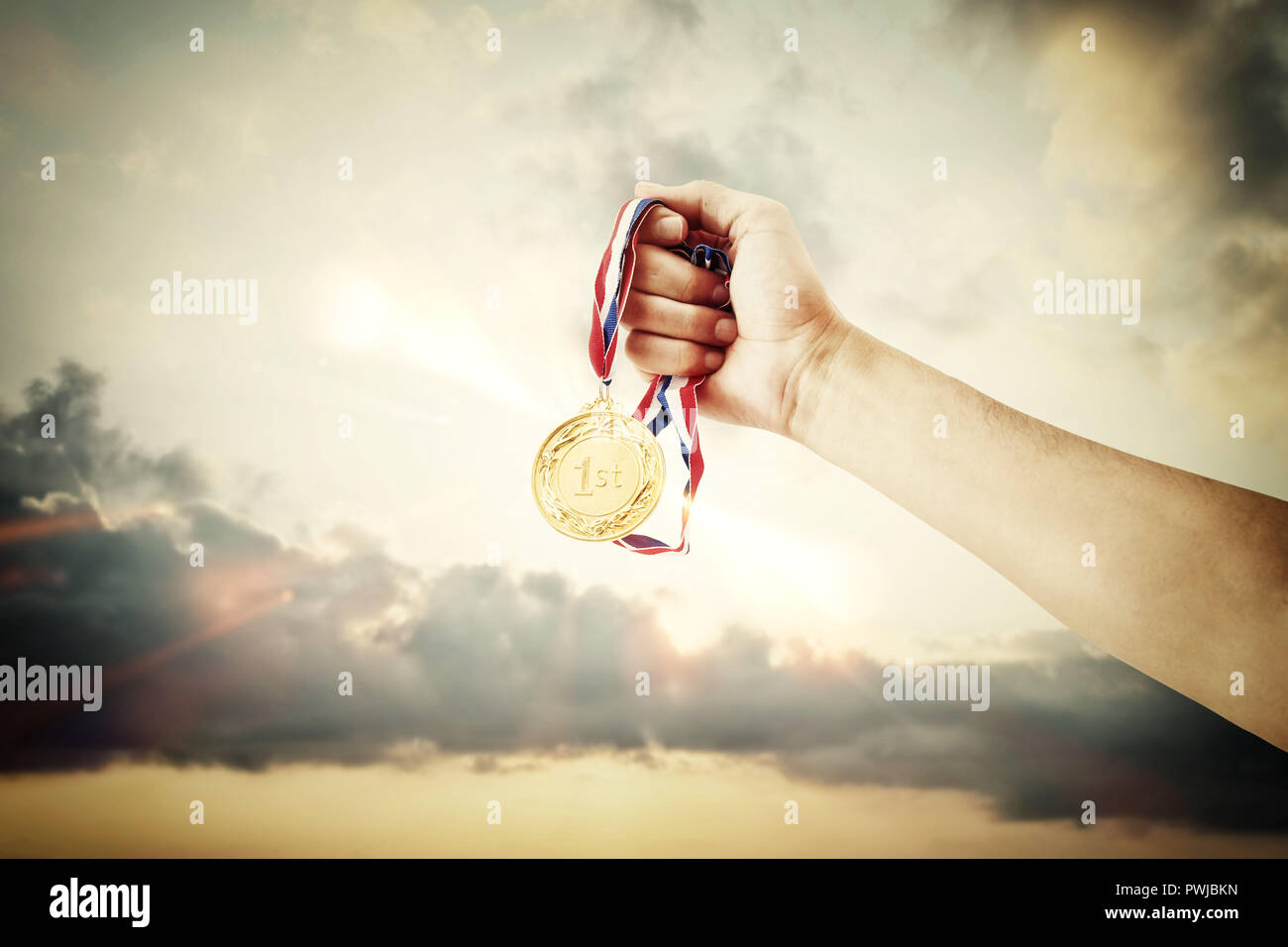 Woman hand raised gold medal hi-res stock photography and images - Alamy