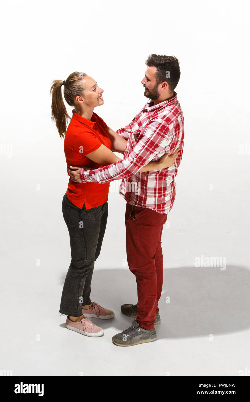 Full body portrait of hugging couple. Caucasian models in love ...