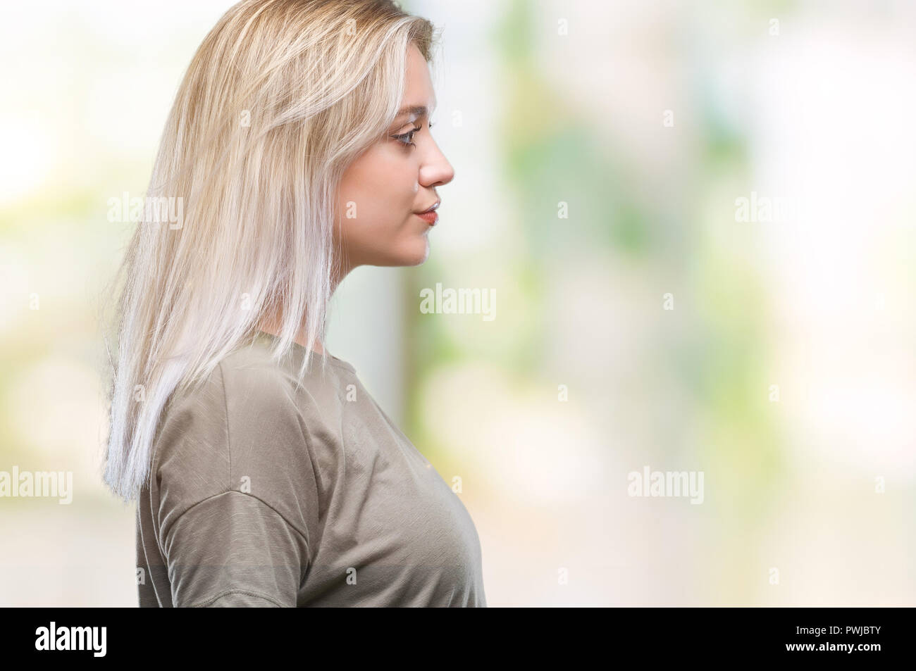 Young blonde woman over isolated background looking to side, relax ...