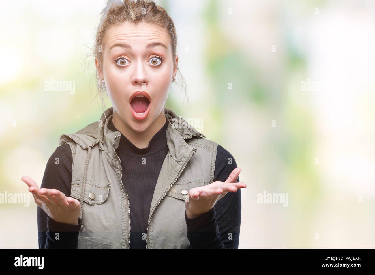 Young blonde woman over isolated background afraid and shocked with ...