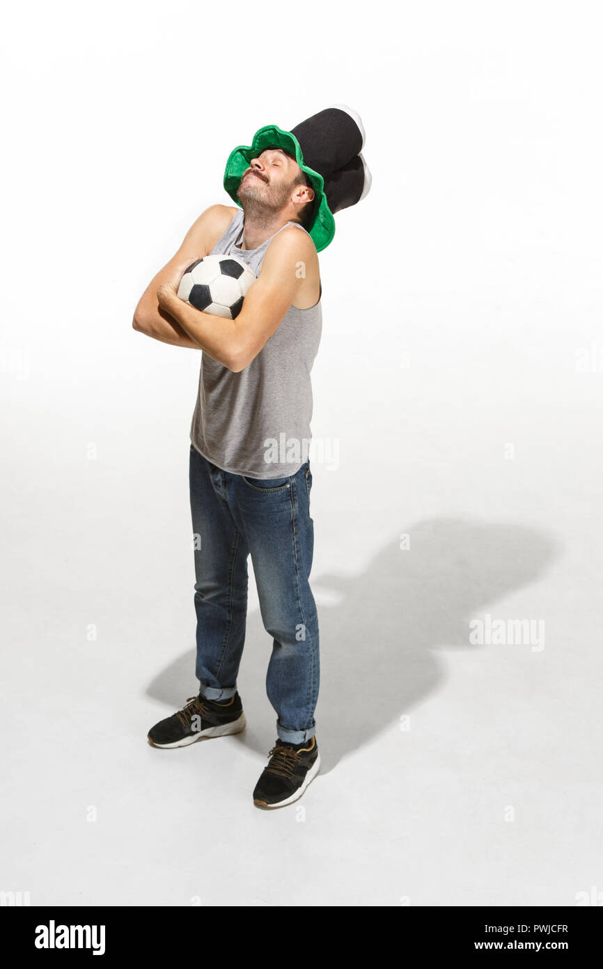 The young football fan - man hugging soccer ball isolated on a white ...