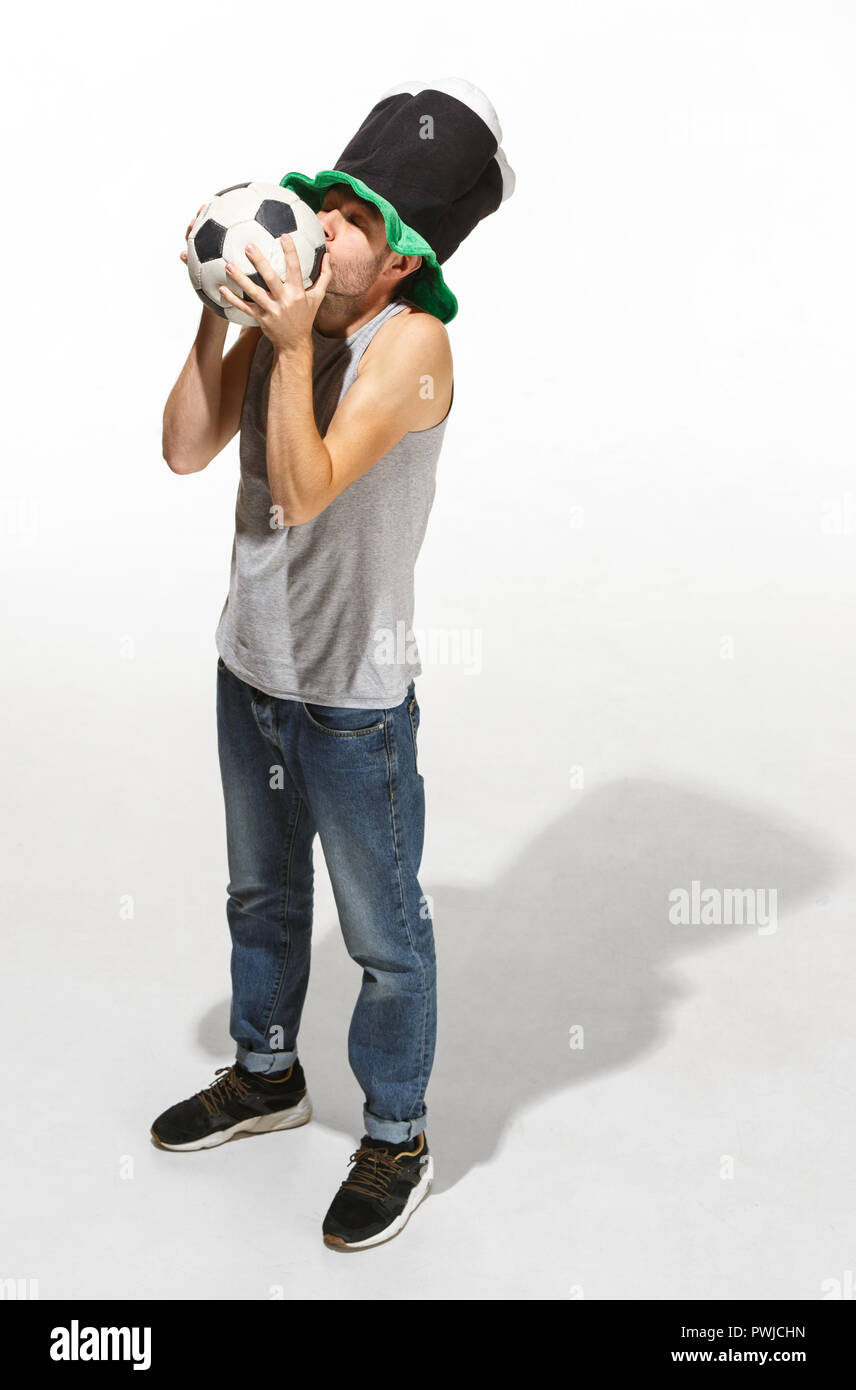 The young football fan - man hugging soccer ball isolated on a white ...