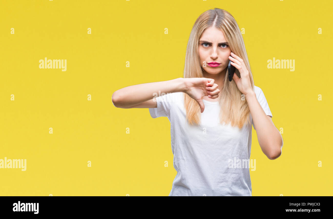 Young beautiful blonde woman talking using smartphone over isolated ...