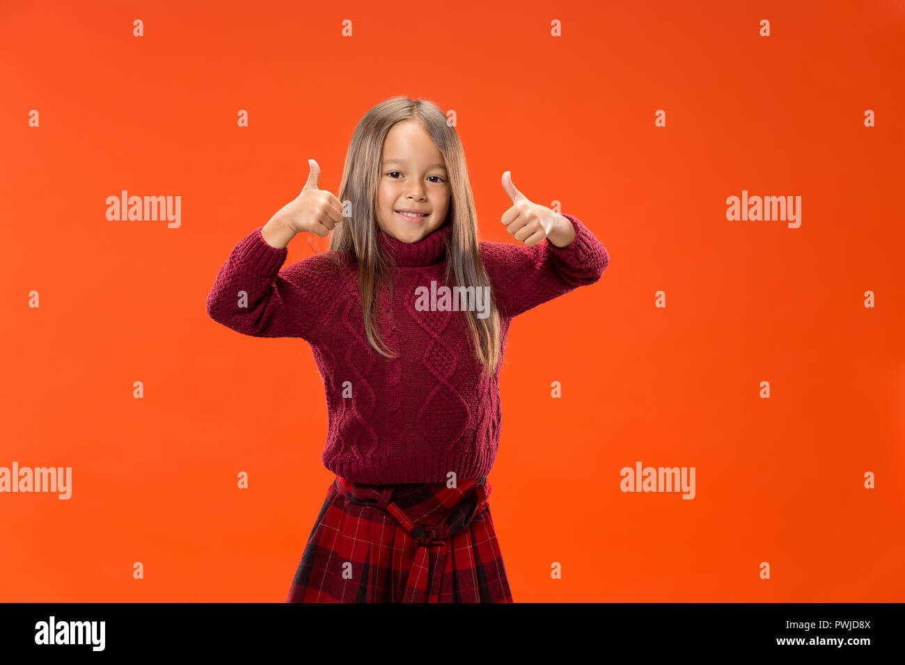 Happy teen girl standing, smiling isolated on trendy studio background ...
