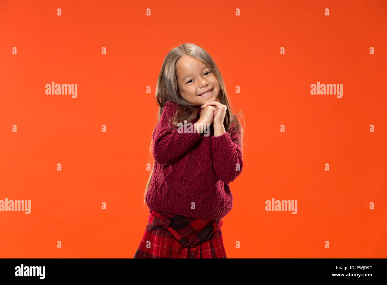 Happy teen girl standing, smiling isolated on trendy studio background ...