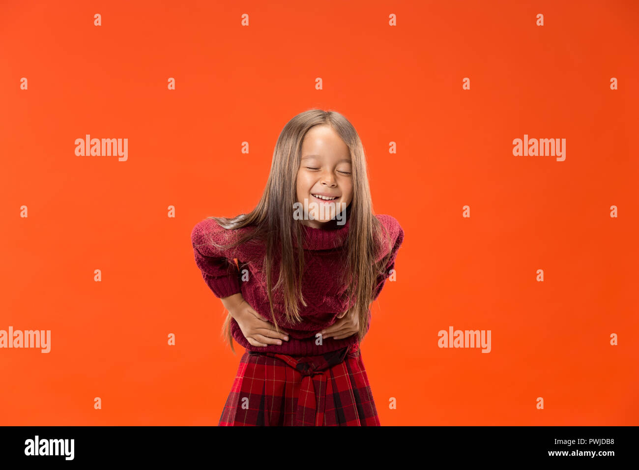 Happy teen girl standing, smiling isolated on trendy studio background ...