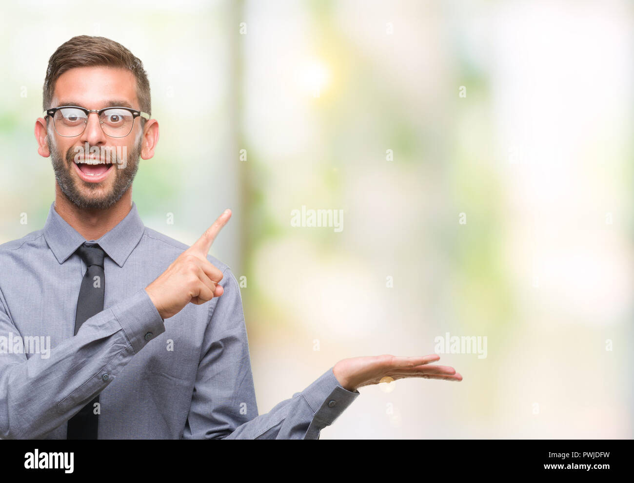 Young handsome business man over isolated background amazed and smiling ...