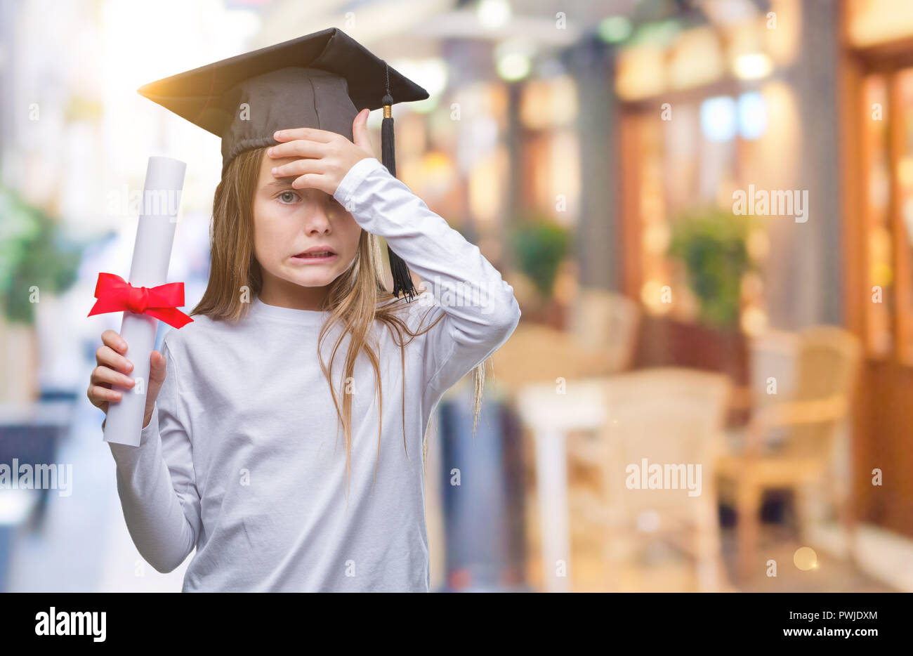 Young beautiful girl wearing graduate cap holding degree over isolated ...