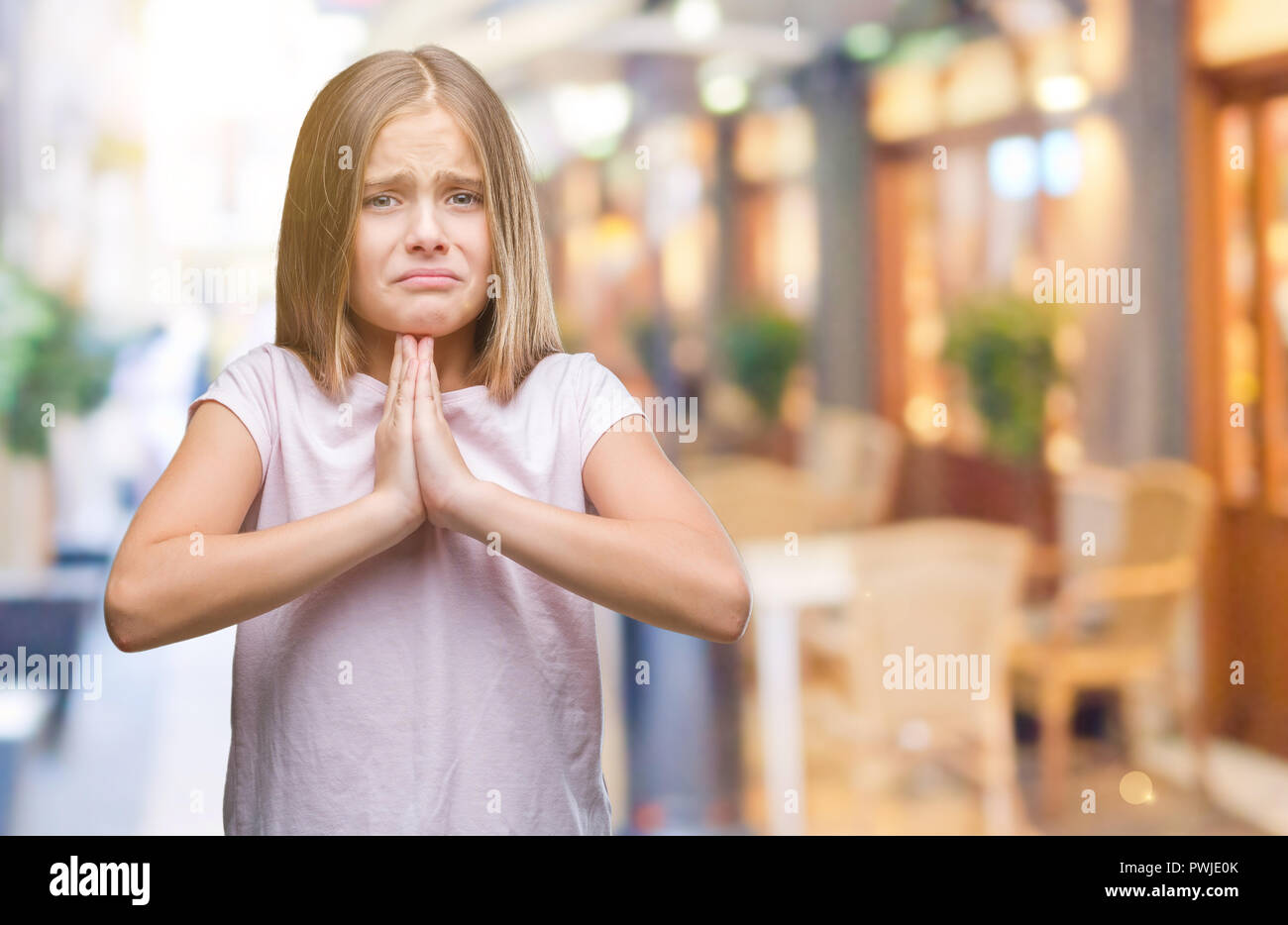 Young beautiful girl over isolated background begging and praying with ...