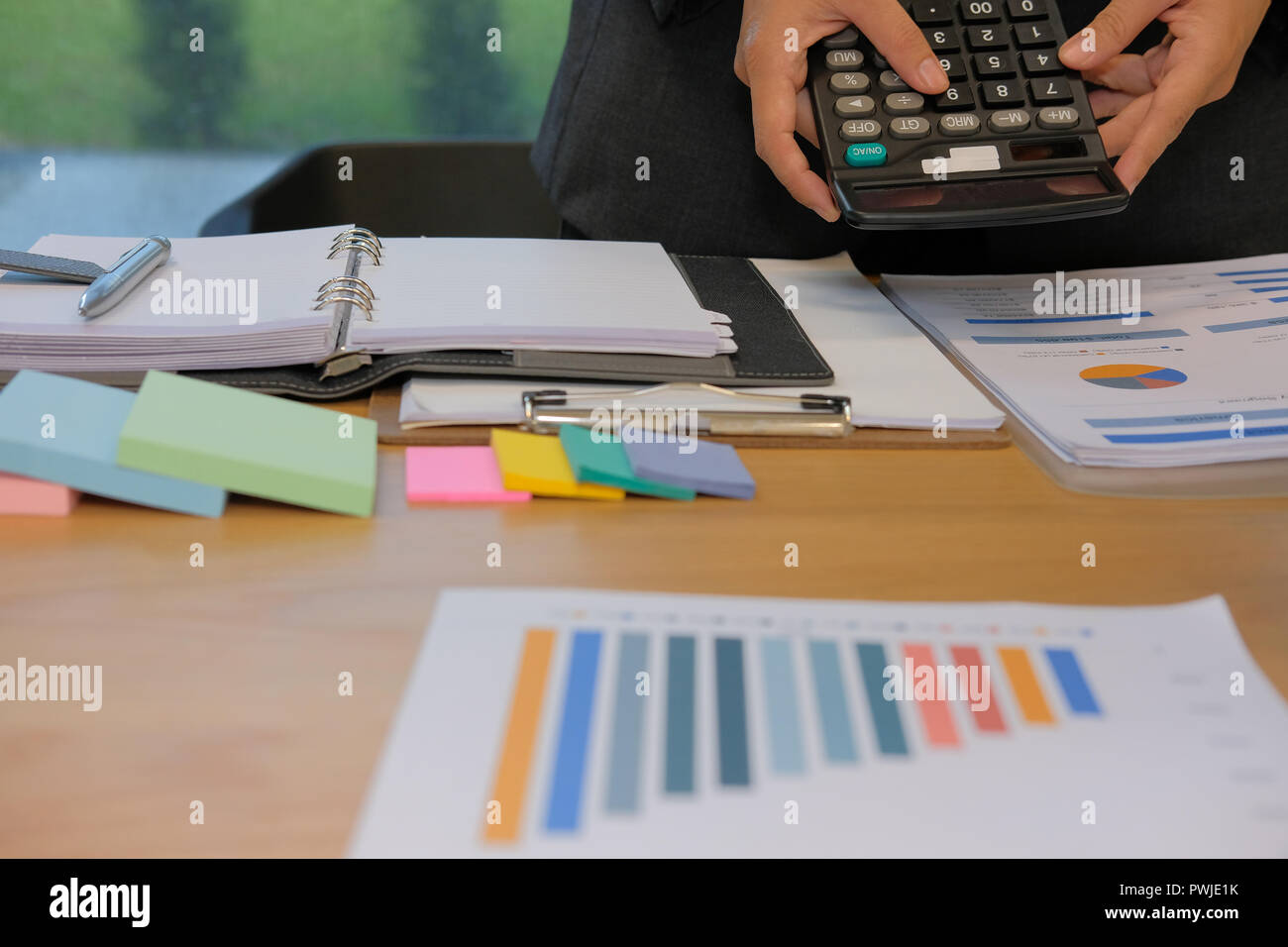 financial adviser working with calculator at office. accountant doing ...