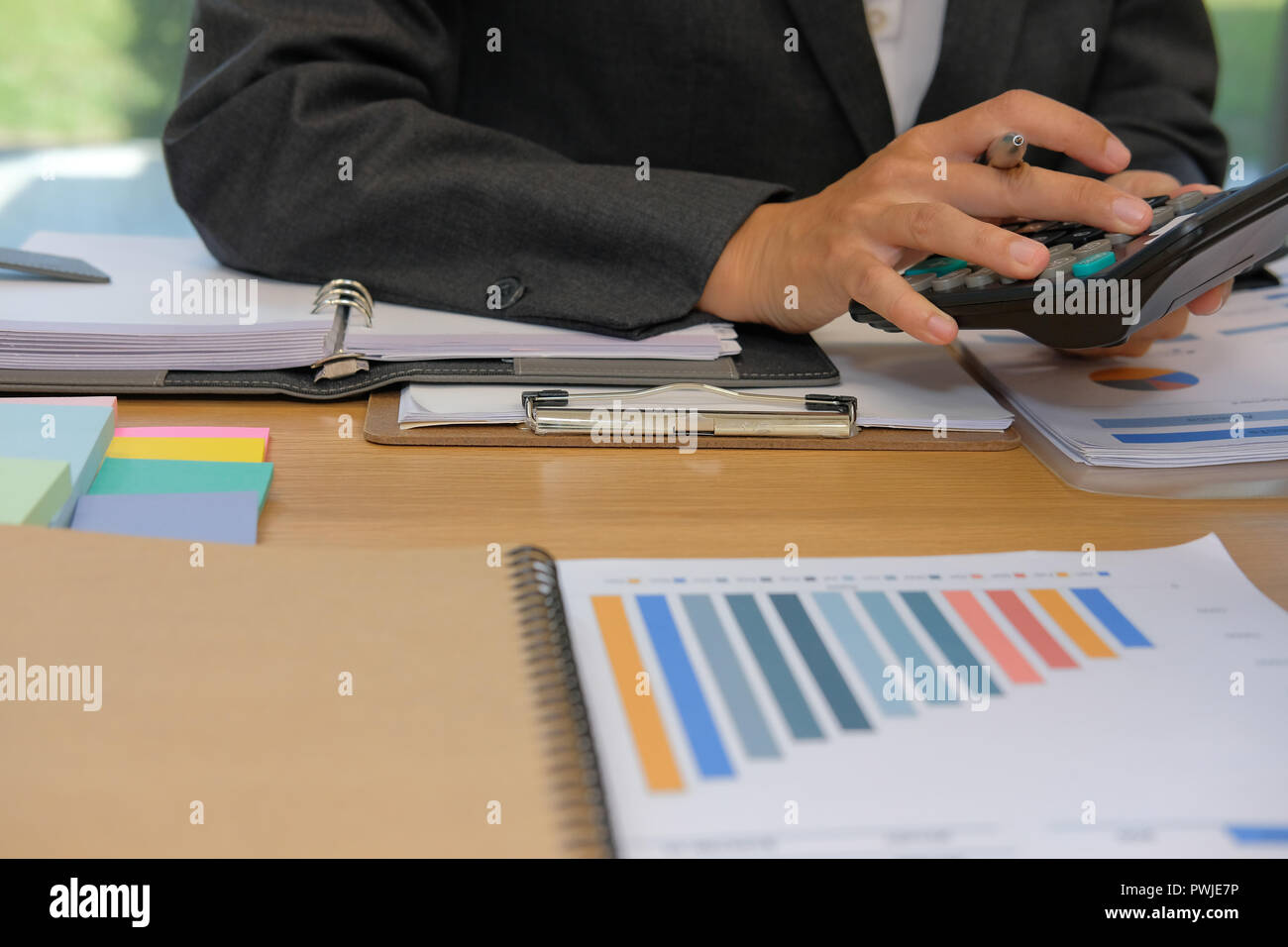 financial adviser working with calculator at office. accountant doing ...