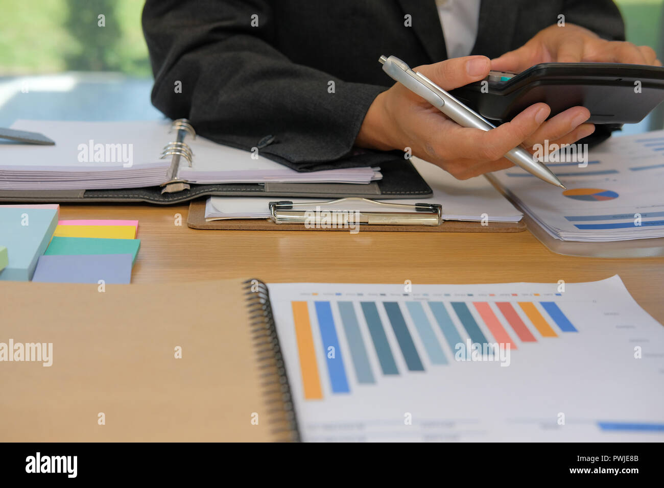 financial adviser working with calculator at office. accountant doing ...