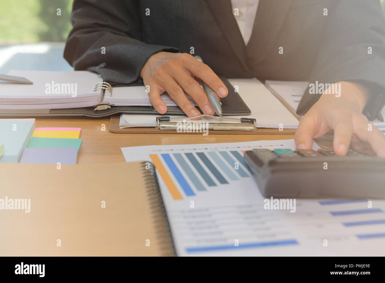 financial adviser working with calculator at office. accountant doing ...