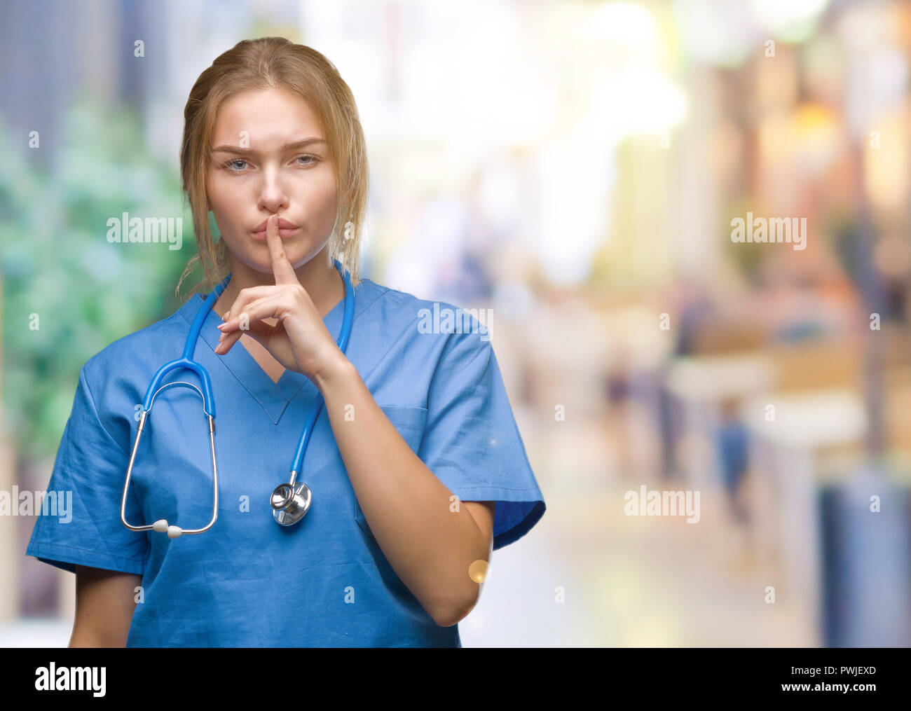 Young caucasian doctor woman wearing surgeon uniform over isolated ...
