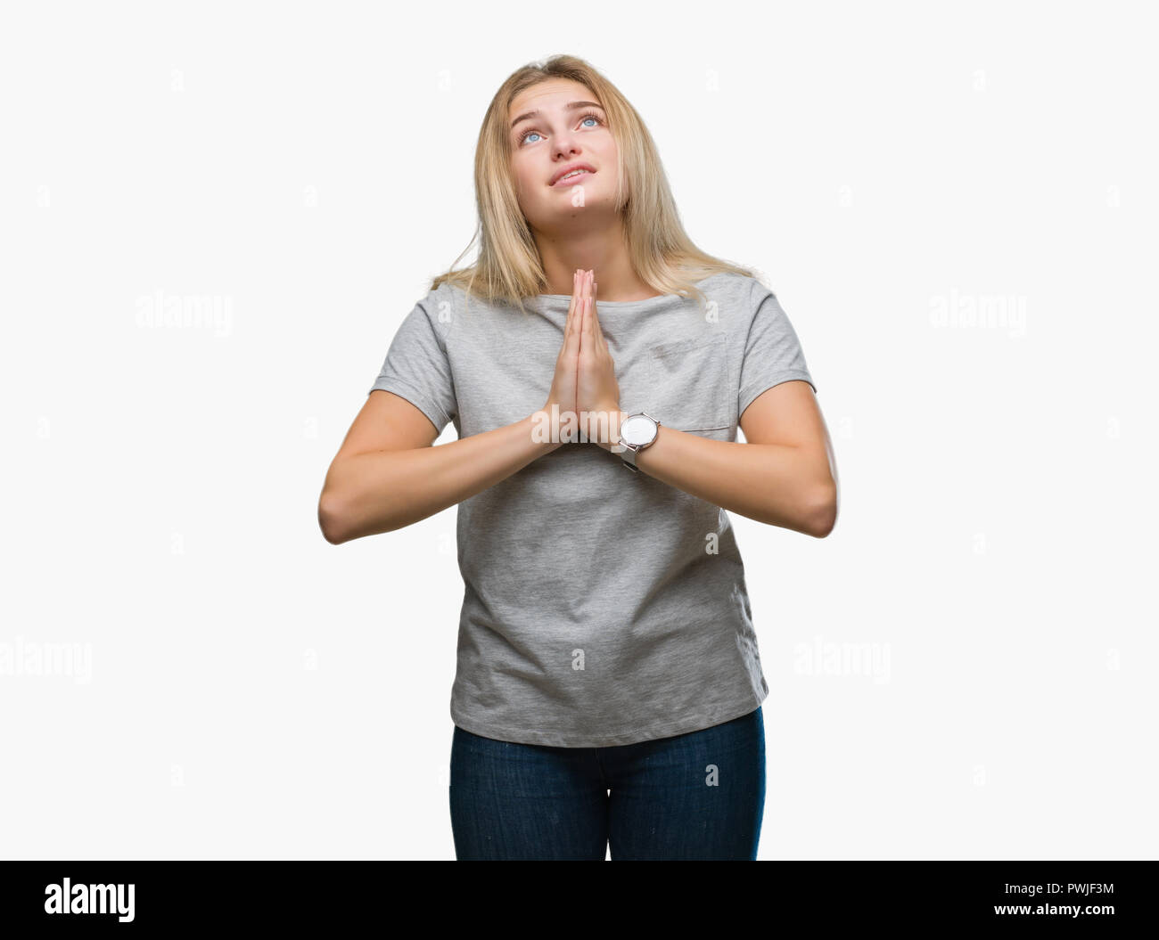 Young caucasian woman over isolated background begging and praying with ...