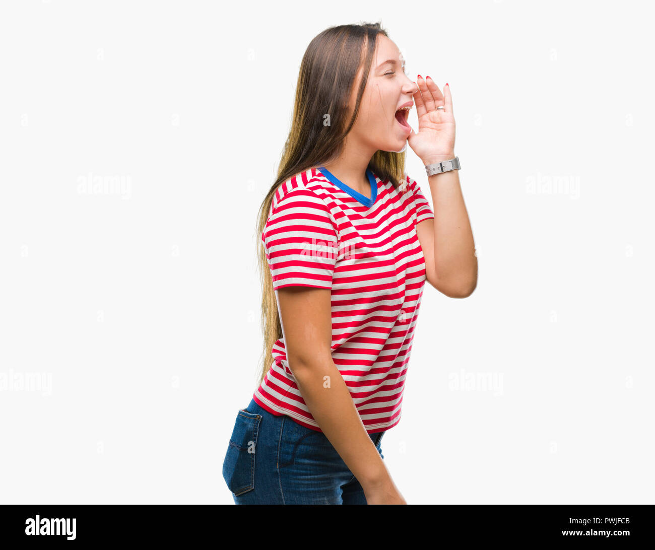 Young caucasian beautiful woman over isolated background shouting and ...
