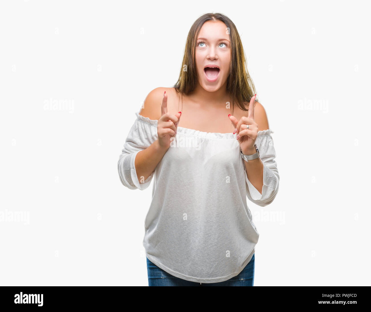 Young caucasian beautiful woman over isolated background amazed and ...