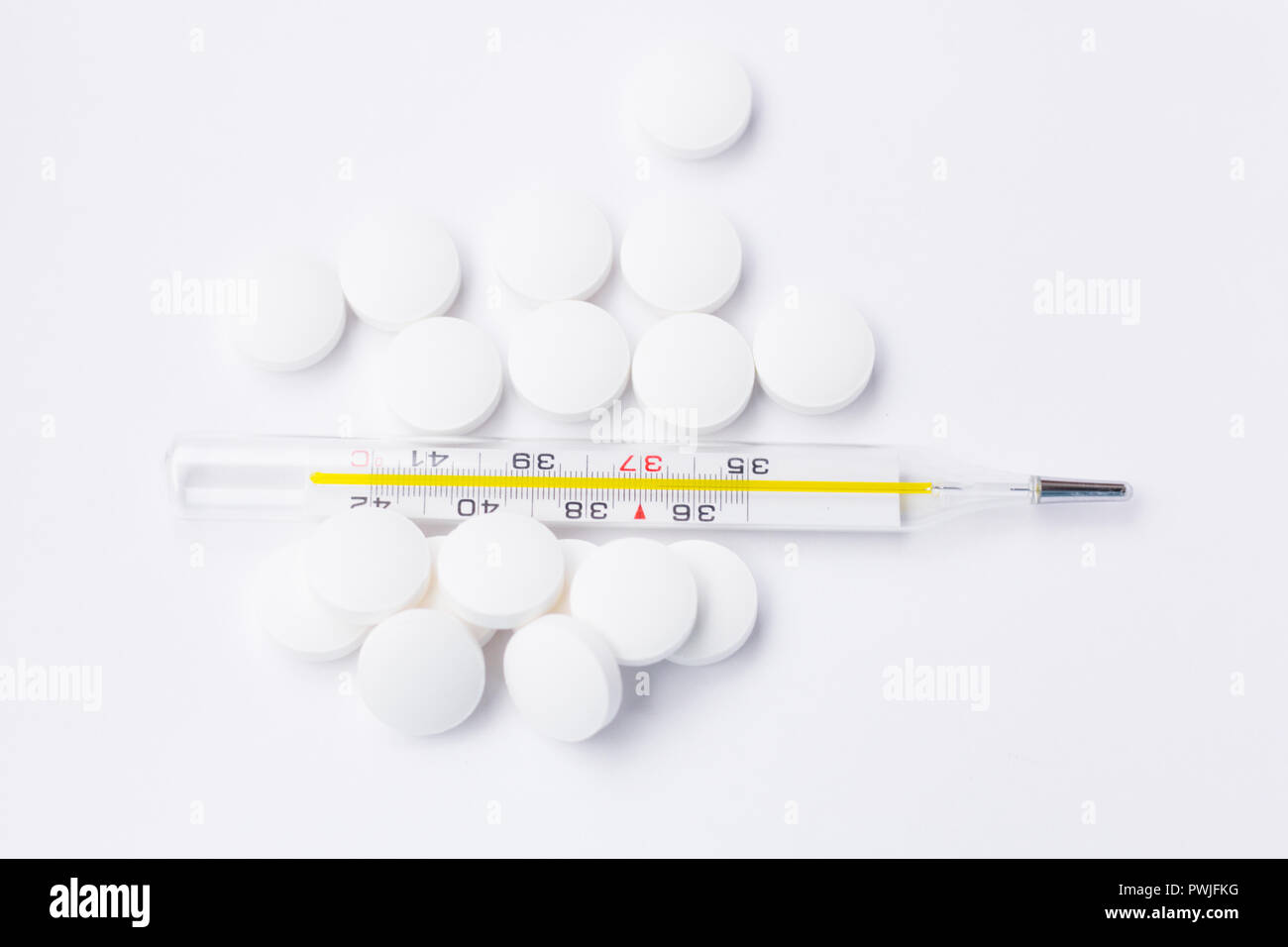 pill and thermometer on a white background. A cure for pain. Health and ...