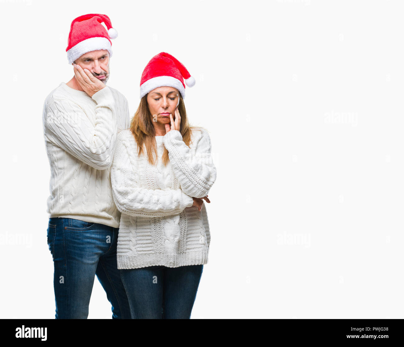 Middle age hispanic couple wearing christmas hat over isolated ...