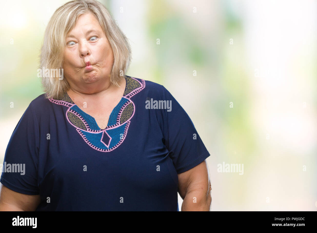 Senior plus size caucasian woman over isolated background making fish ...