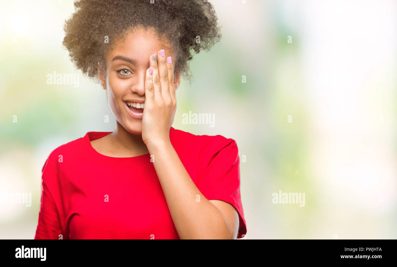 Young afro american woman over isolated background covering one eye ...