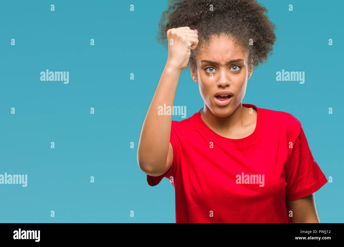 Young afro american woman over isolated background angry and mad ...