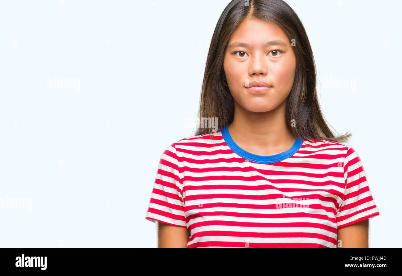 Young asian woman over isolated background with serious expression on ...
