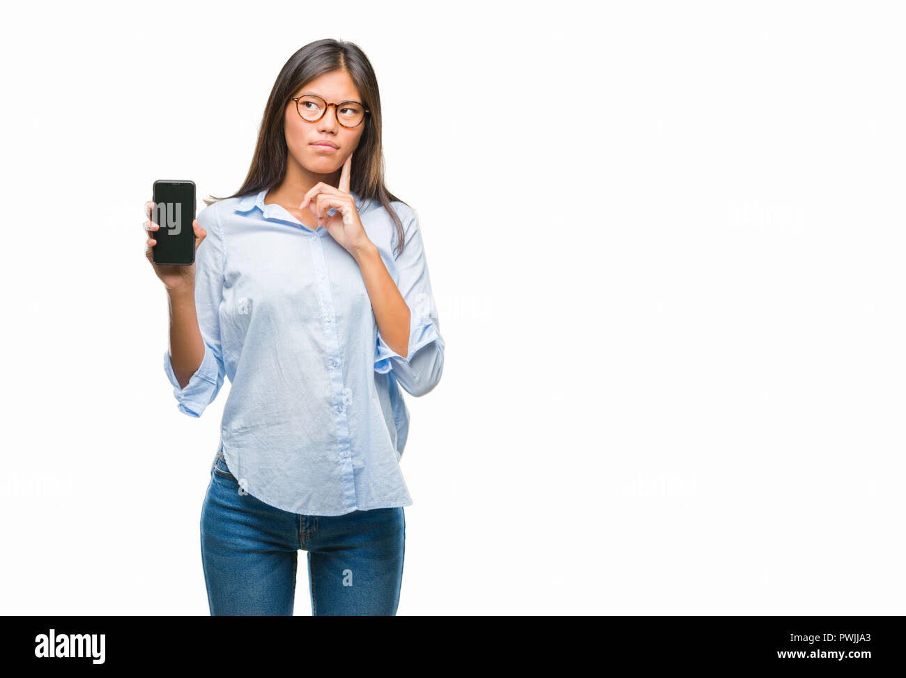 Young asian woman showing smartphone blank screen over isolated ...