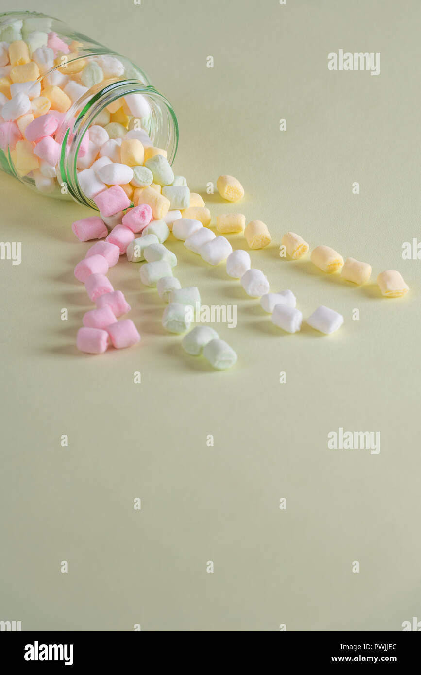 Fluffy marshmallow overspill on a greenish background from a jar Stock ...