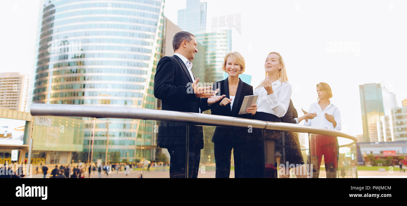 Businesswomen speaking with male boss outside Stock Photo - Alamy