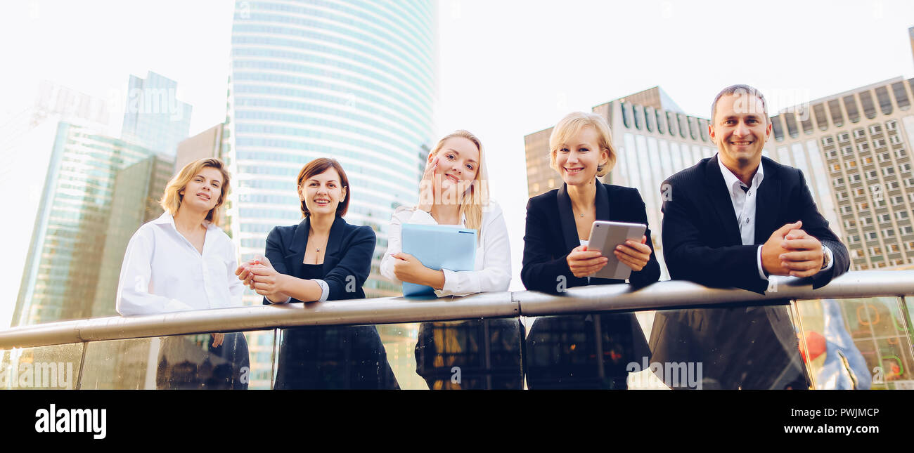 Close up faces financial team looking at camera keeping document Stock ...