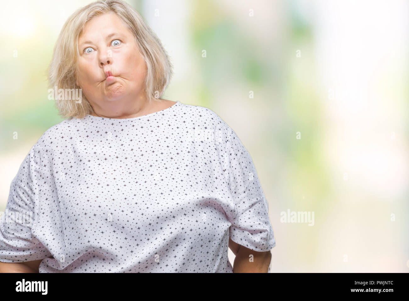 Senior plus size caucasian woman over isolated background making fish ...