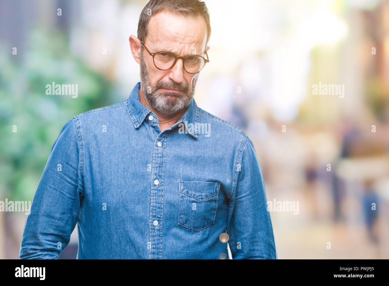 Middle age hoary senior man wearing glasses over isolated background ...