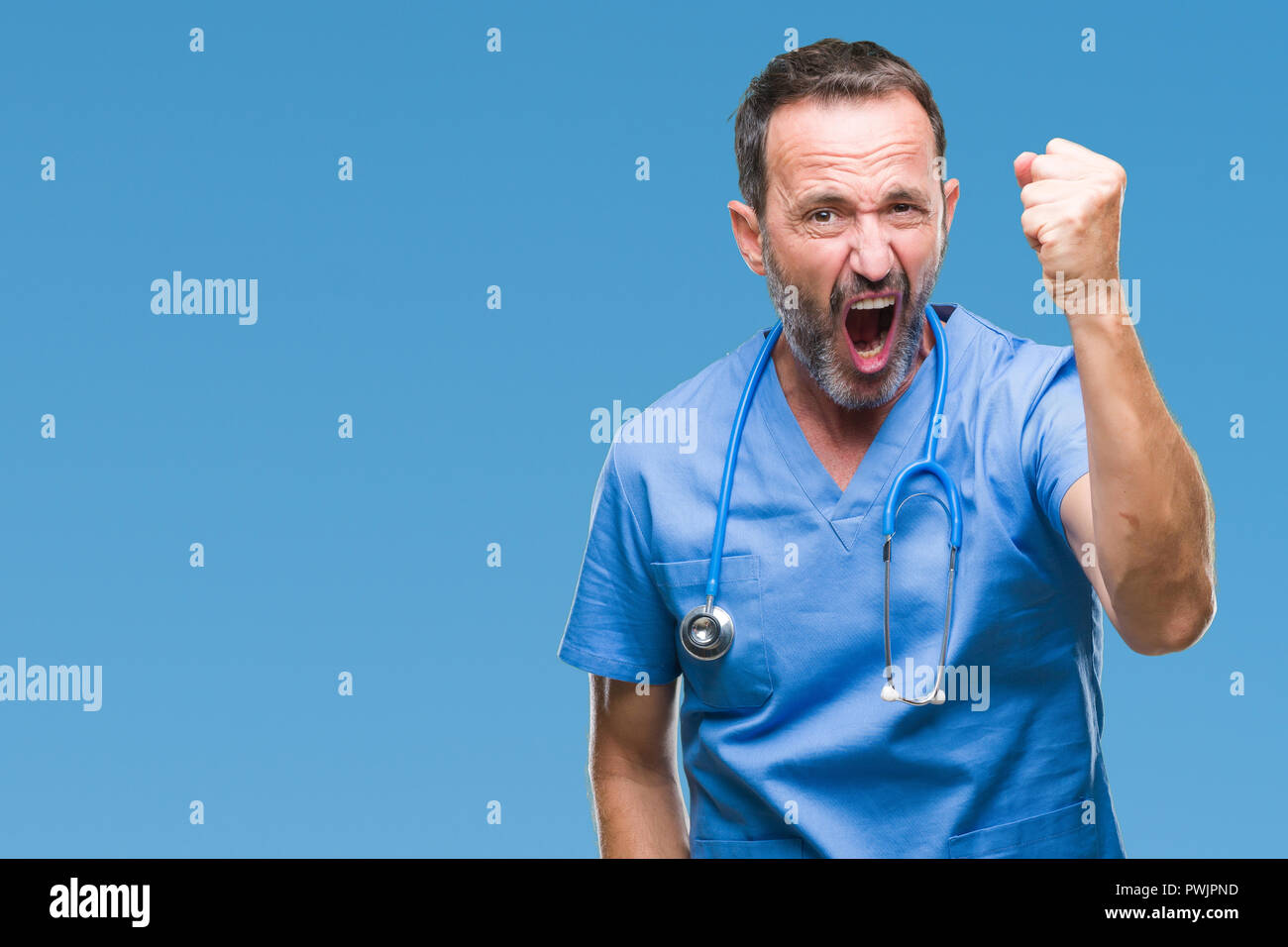Middle age hoary senior doctor man wearing medical uniform over ...