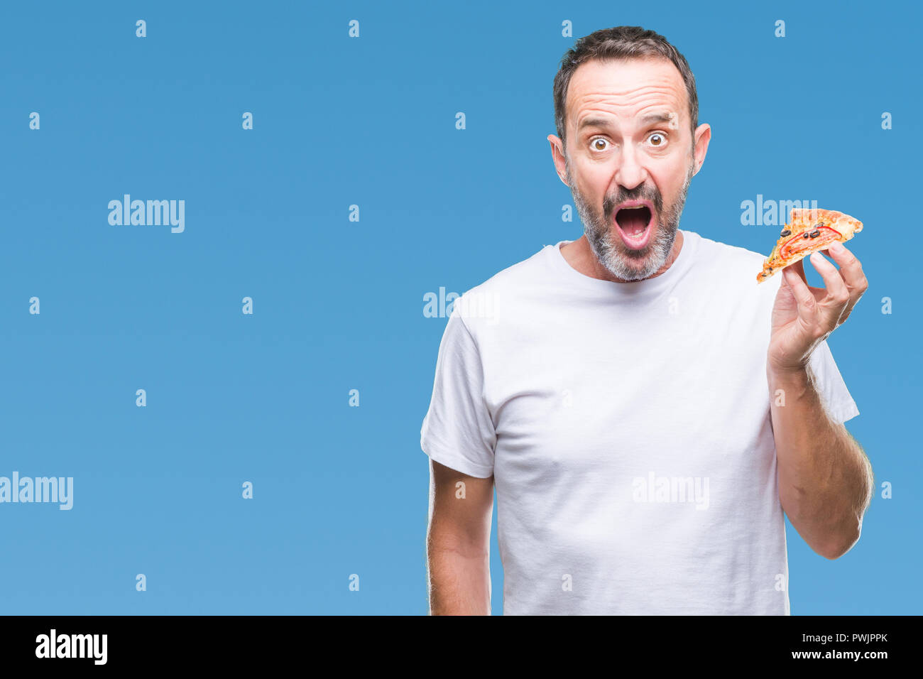 Middle age hoary senior man eating pizza slice over isolated background ...