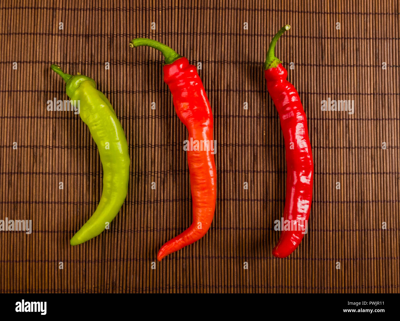 a colorful mix of the freshest and hottest chili peppers on a bamboo ...
