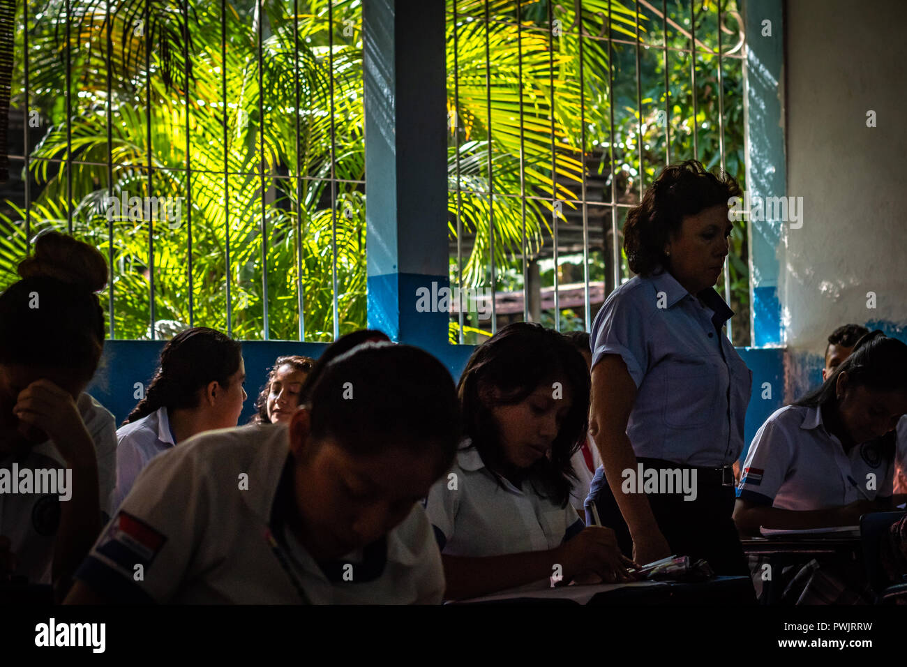 teacher helping students in guatemalan college Stock Photo - Alamy