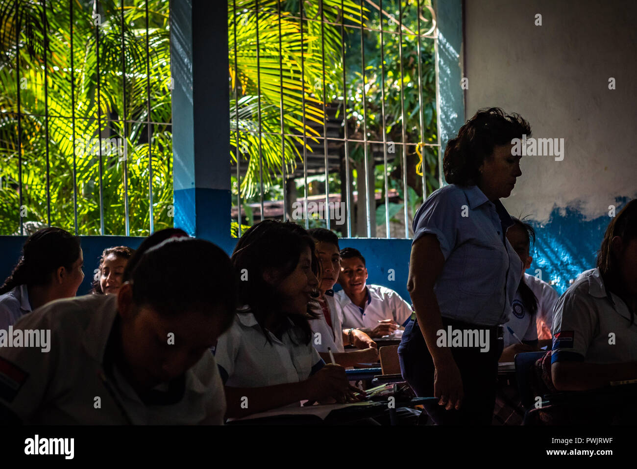 teacher helping students in guatemalan college Stock Photo - Alamy